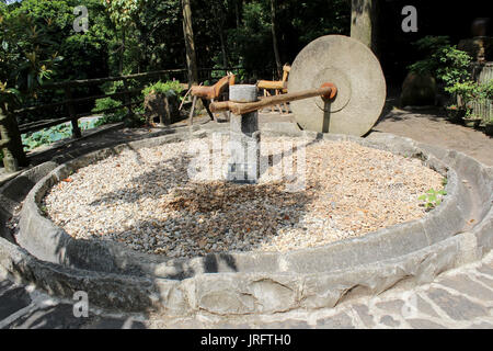 Old stone mortar for Rice processing in vietnam Stock Photo - Alamy