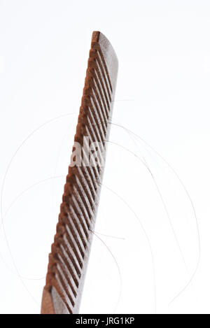 Hair brush with strand on color wooden background Stock Photo - Alamy