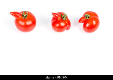 Deformed aberrant abnormal anomalous red tomato on a white background ...