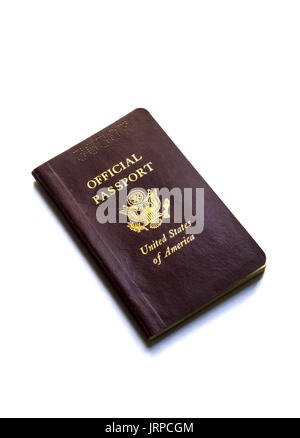 A reddish brown Official US passport is shown against a white ...
