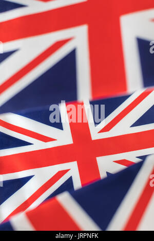 Cluster of mini Union Jack flags. Metaphor British patriotism, being ...