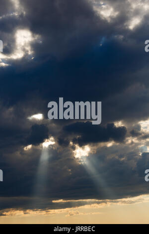 Sun light rays beaming into the blue green water and highlighting the ...