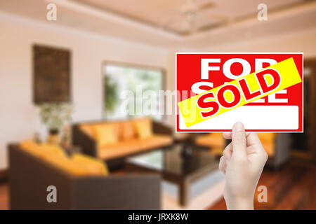 hand holding sold house sign Stock Photo - Alamy