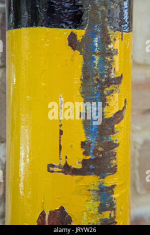 Accident damaged yellow car park post Stock Photo - Alamy