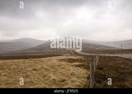 Road slicing through vast treeless mountain landscape of Cairngorms ...
