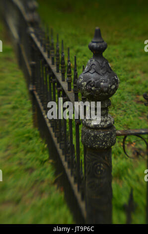 vintage iron fence posts weather mossy Stock Photo - Alamy