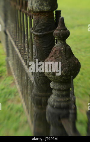 vintage iron fence posts weather mossy Stock Photo - Alamy