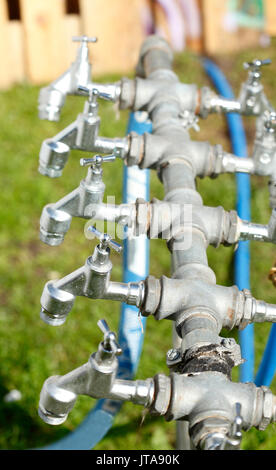 silver metal outside water taps with multiple connection Stock Photo ...