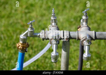 silver metal outside water taps with multiple connection Stock Photo ...