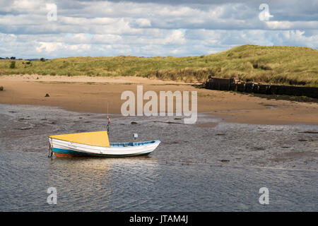Coble traditional fishing boat moored in Staithes harbour on the North ...