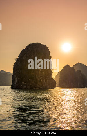 Sunset over the karst seascape of Ha Long Bay in Vietnam, Southeast ...