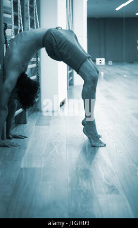 Yoga teacher doing backbend bridge flexibility and strength asana ...