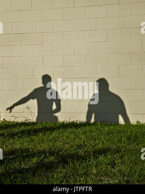 Shadows of people cast on a wall Stock Photo - Alamy