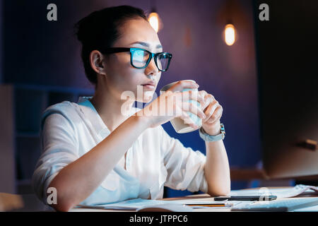 Young employee working late in the office Stock Photo - Alamy