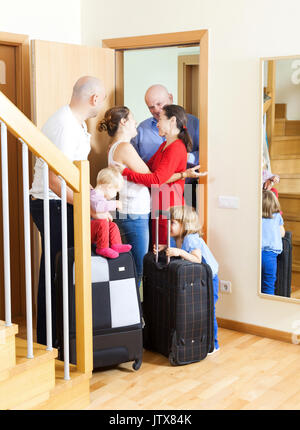 Couple greeting their guests at the door of their home Stock Photo ...