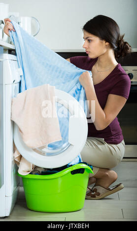 Adult woman with musty towels after laundry at home Stock Photo - Alamy