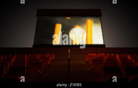 An illuminated stadium big screen showing a soccer replay in the stands ...