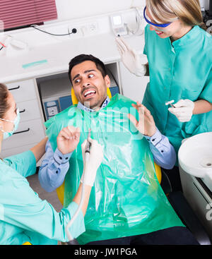 Portrait of doctor and frightened patient at dental office Stock Photo ...