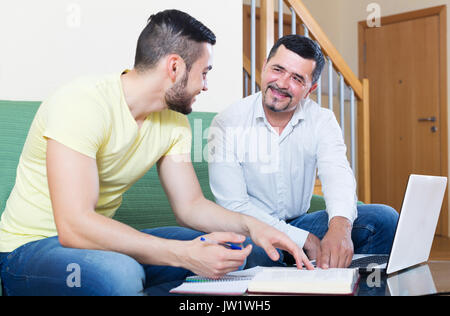 Professor giving private lesson to student at home Stock Photo - Alamy