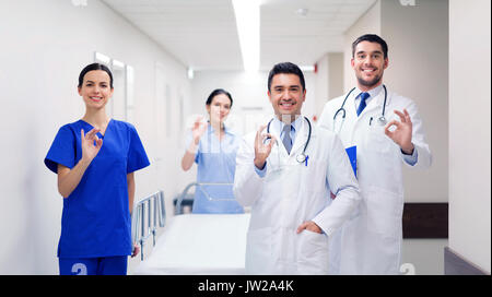 happy doctors with gurney showing ok at hospital Stock Photo - Alamy