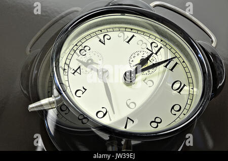 close up of two, overlapping images with retro alarm clocks, showing ...