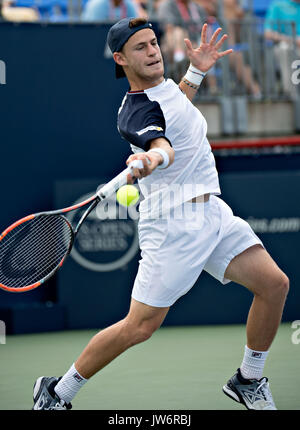 Jared Donaldson of the United States returns a shot to Denis Istomin of ...