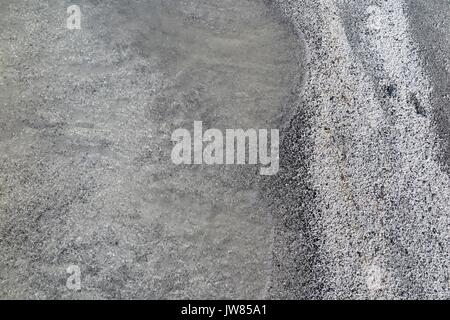 Grey abstract background of wet sand texture occured by sea waves on ...