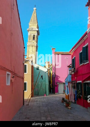 Cozy, rural Italian street scene with a flesh-colored wooden gate ...