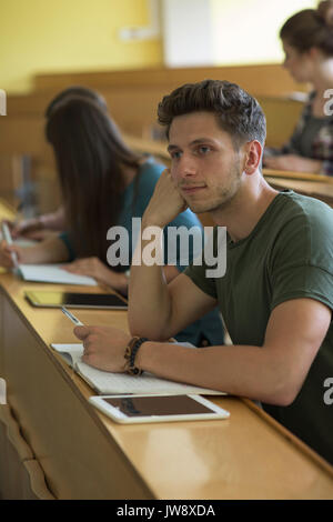 Student Desk in a classroom for learning with feathered pen and paper ...