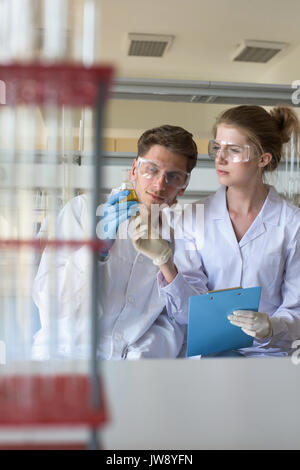 Male student performing an experiment Stock Photo - Alamy