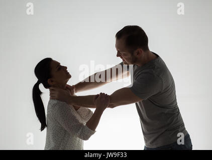 Aggressive woman choking man argue or quarrel with lover. Jealous ...