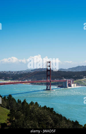 A vertical shot of the Golden Gate Bridge surrounded by clouds, San ...