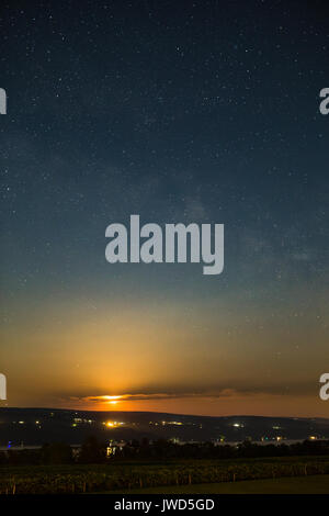 Moon rising over vinyard and lake under stars and milky way Stock Photo ...