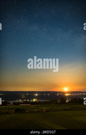 Moon rising over vinyard and lake under stars and milky way Stock Photo ...