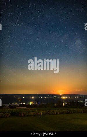 Moon rising over vinyard and lake under stars and milky way Stock Photo ...