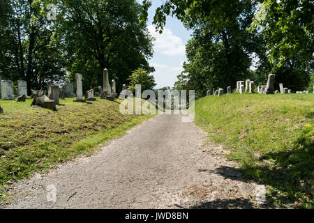 Gravel road in a graveyard located in a city Stock Photo - Alamy
