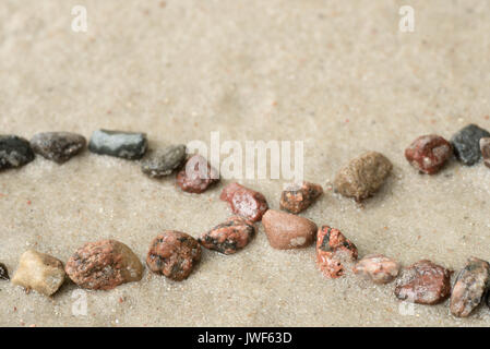 pebble infinity symbol on sand background selective focus Stock Photo ...