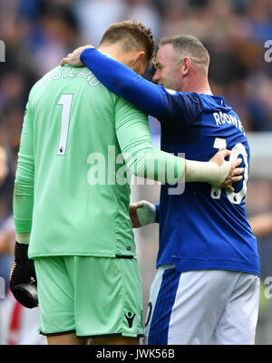 Everton's Wayne Rooney (left) and Stoke City's Joe Allen in action ...