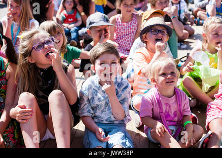 Facing audience of young children, 4-9 years old, sitting crowded ...