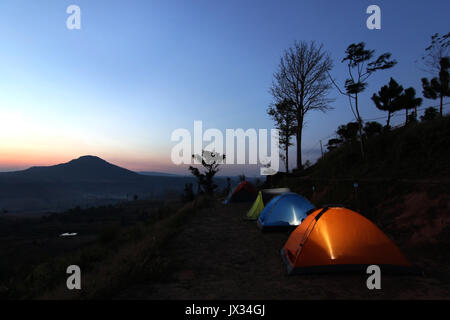 camping tents at twilight time with mountain background Stock Photo - Alamy