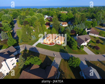 an aerial view of a house in the middle of a residential area, taken ...