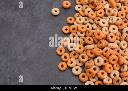 Multigrain hoops breakfast cereal in an American cup measure, isolated ...