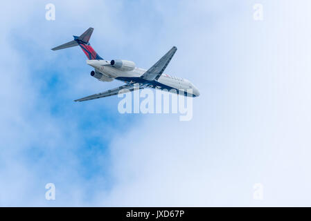 Passenger plane of Delta Airlines flying over New York City area ...