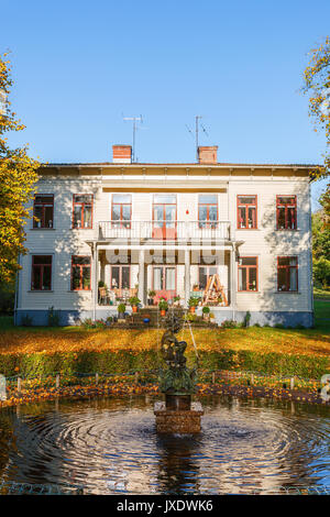 House with a fountain in a beautiful garden near the forest, in early ...
