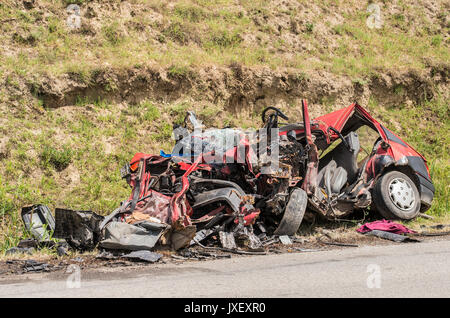 Unrecognizable car wreck beside a road Stock Photo - Alamy