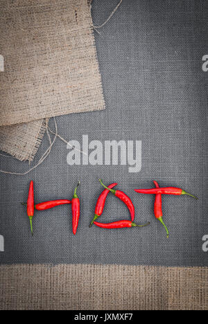 Red chilli peppers arranged to spell out RED HOT CHILI . The chillies ...