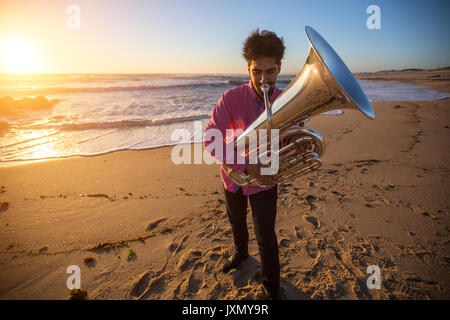 Musician play to musical instrument Tuba on romantic sea shore Stock ...