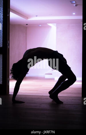 Yoga teacher doing backbend bridge flexibility and strength asana ...