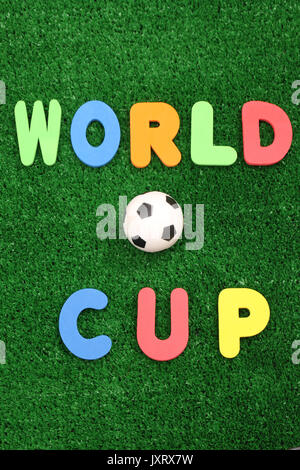 Teams ball on atificial turf - word plastic colours Stock Photo - Alamy