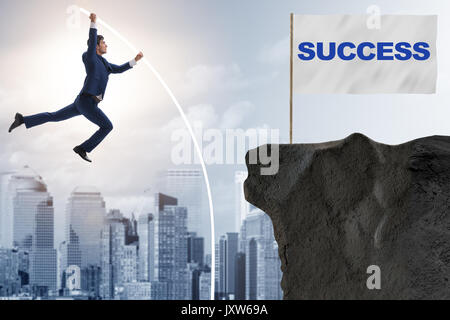 Businessman pole vaulting towards his success goal Stock Photo - Alamy
